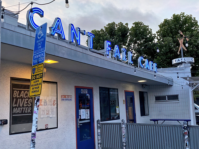 The iconic blue neon sign beckons hungry travelers like a culinary lighthouse. Rudy's Can't Fail Cafe doesn't just promise a meal—it delivers an experience.