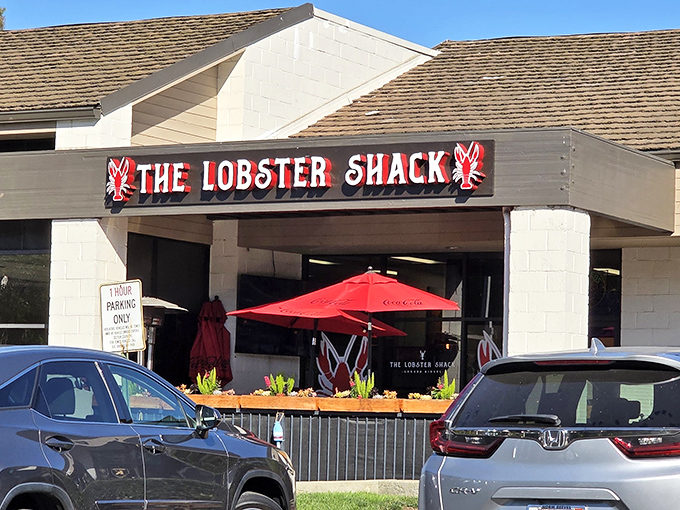 Another angle reveals the cozy patio setup, where red umbrellas stand guard over countless seafood feasts and post-meal food comas.