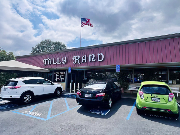 The iconic salmon-colored exterior of Tallyrand stands proudly under California skies, an unassuming temple to comfort food that's been calling diners home for decades.