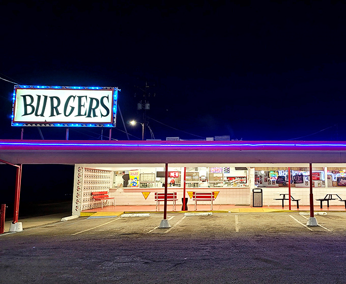 That neon "BURGERS" sign isn't just advertising &ndash; it's a beacon of hope for the hungry and a portal to simpler times.