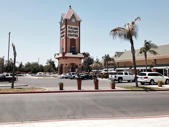 Tulare Outlet Center greets shoppers with its clock tower and palm-lined walkways, offering a mix of style and savings in the heart of California.