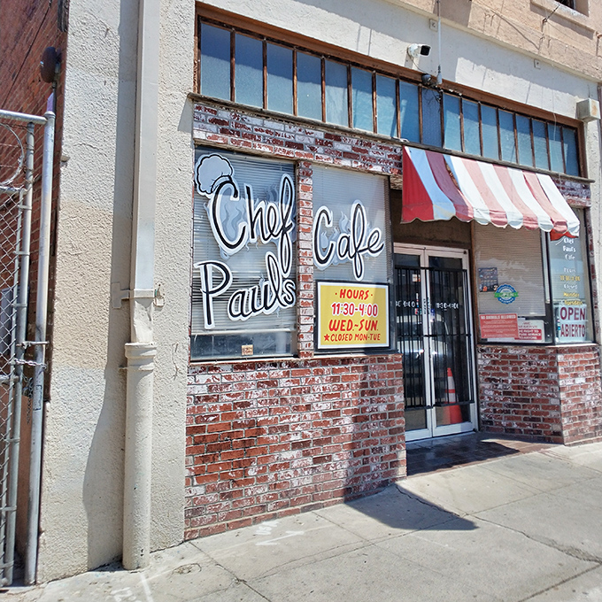 The unassuming exterior of Chef Paul's Cafe, with its vintage Pepsi sign and red-and-white awning, promises authentic flavors hiding in plain sight.