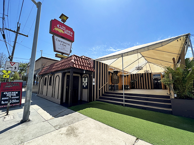 Bathed in California sunshine, Golden Bull's distinctive black-and-white striped exterior and outdoor dining tent create an inviting first impression that whispers, "Come in, the prime rib is waiting."