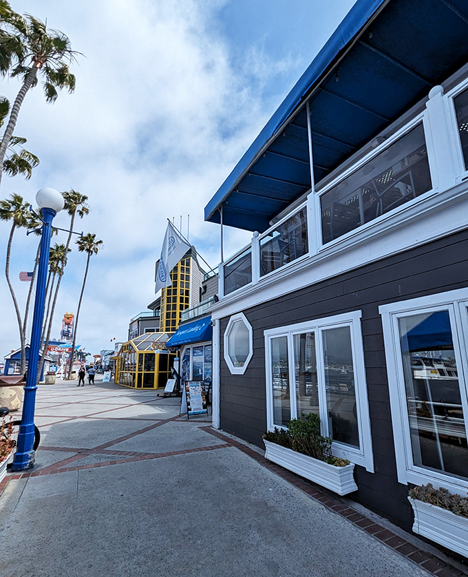 Palm trees sway in greeting as Newport Landing's charming maritime exterior invites you to step out of everyday life and into coastal bliss.