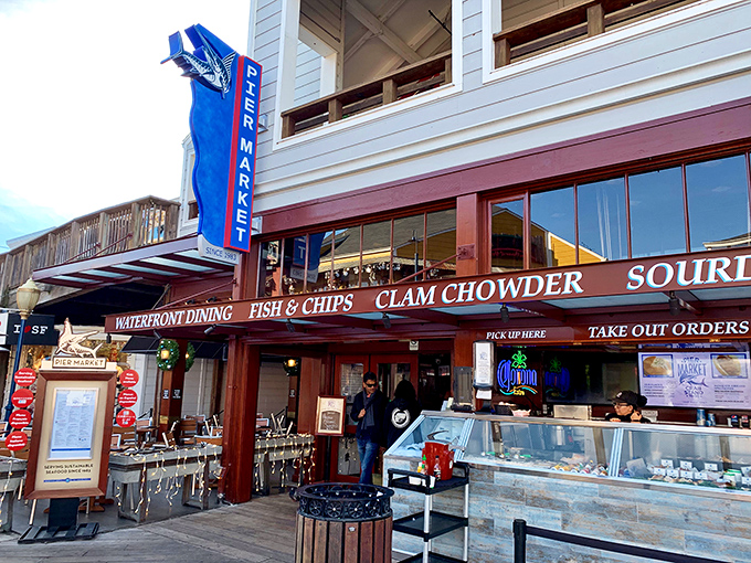 The blue vertical sign beckons hungry visitors like a lighthouse for the famished. "Fish & Chips" and "Clam Chowder" &ndash; six magic words that promise maritime delights.