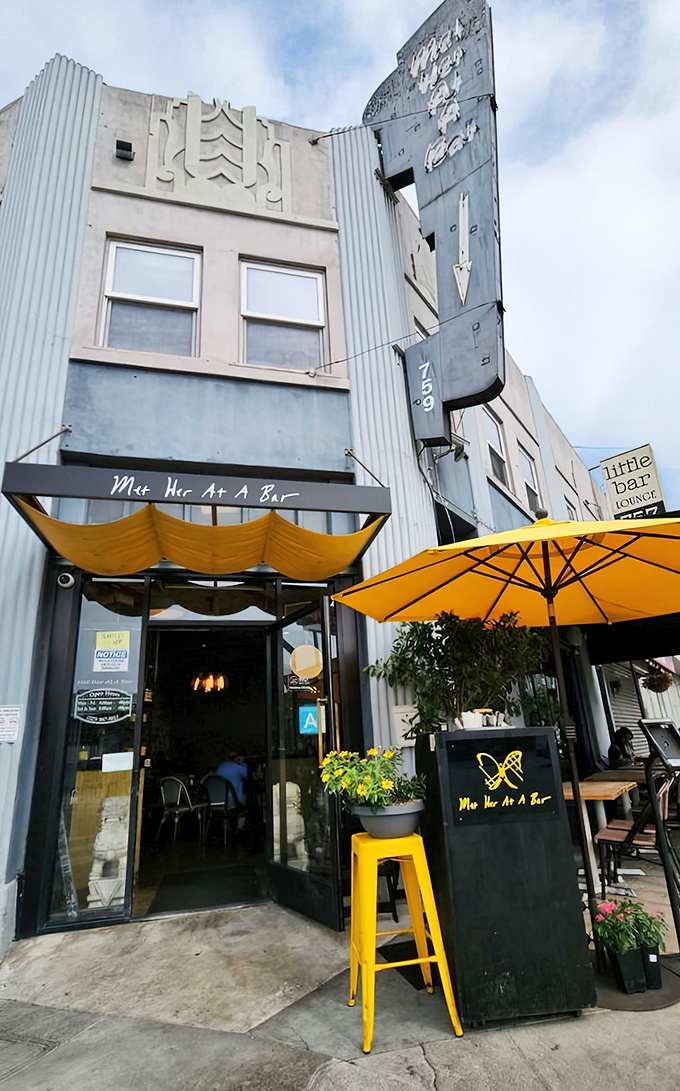 The unassuming exterior hides a brunch paradise where yellow umbrellas signal good times ahead.