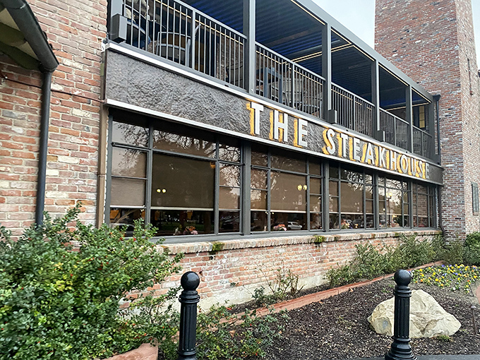 Gold lettering announces your arrival at meat paradise. The brick exterior and manicured landscaping hint at the classic experience waiting inside.