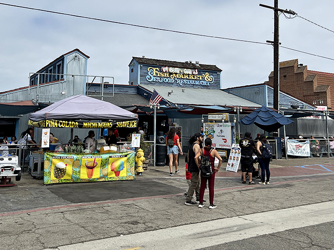 Red awnings flutter in the ocean breeze as patrons make their pilgrimage to this temple of seafood. The corrugated metal exterior might not scream "gourmet" but locals know better.