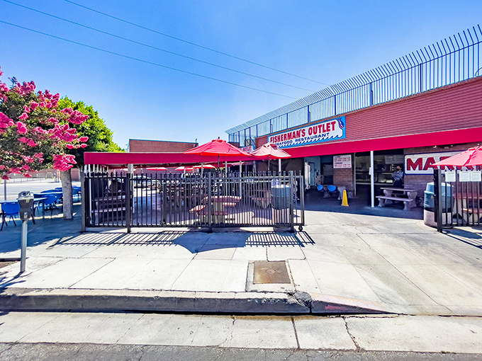 The vibrant red umbrellas of Fisherman's Outlet beckon like maritime flags signaling "fresh seafood ahead" in downtown LA's concrete landscape.