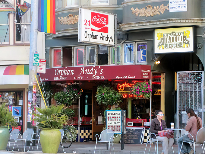 The iconic red awning of Orphan Andy's beckons like a beacon of breakfast hope in San Francisco's Castro district, promising 24-hour comfort food salvation. 