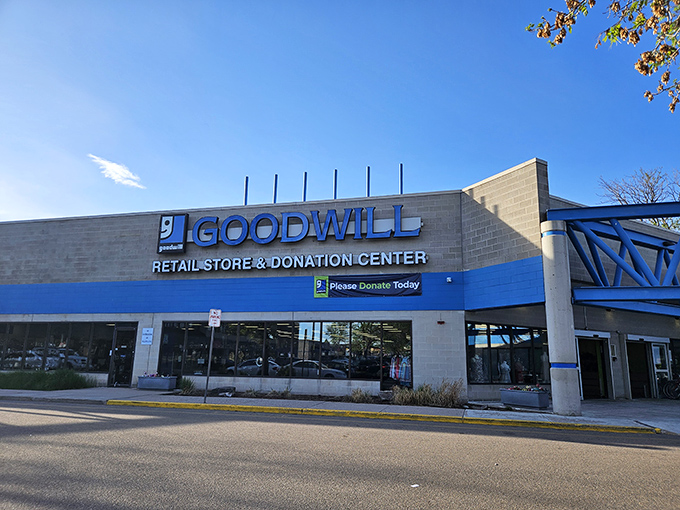 The blue and white facade of Goodwill beckons like a retail oasis in Aurora, promising treasures waiting to be discovered inside.