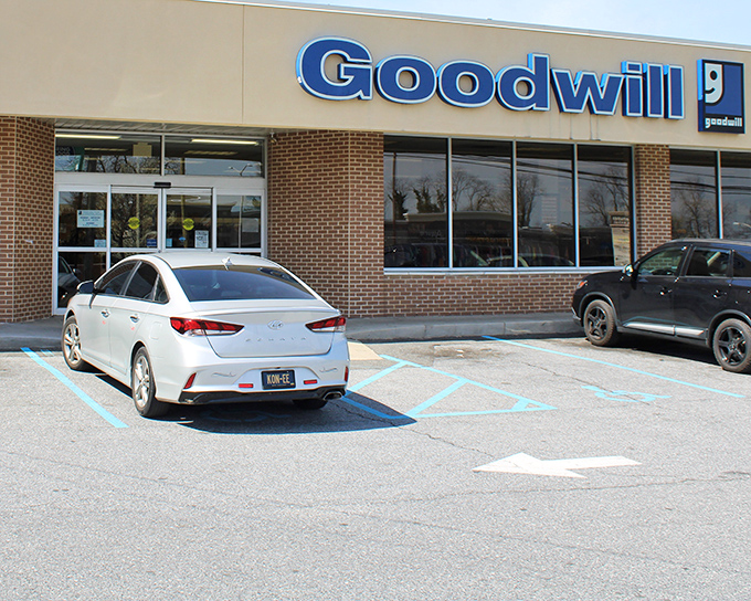 The iconic blue Goodwill sign beckons bargain hunters like a retail lighthouse in the sea of Delaware shopping options.