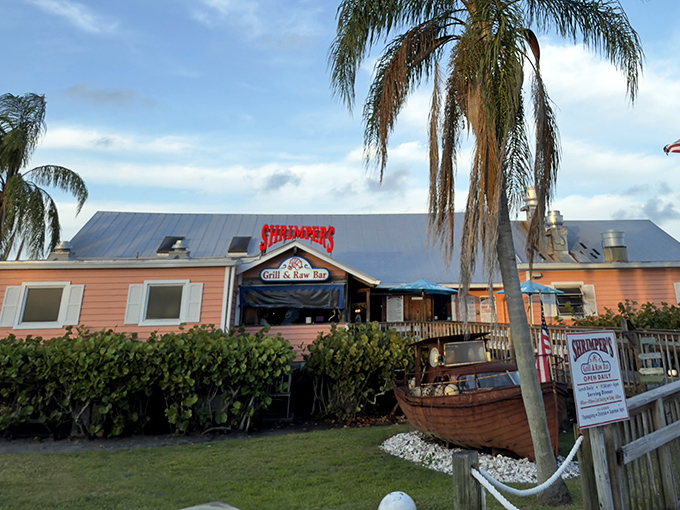 The peach-colored exterior of Shrimpers stands like a cheerful sentinel against Florida's blue sky, promising seafood treasures within its humble walls.
