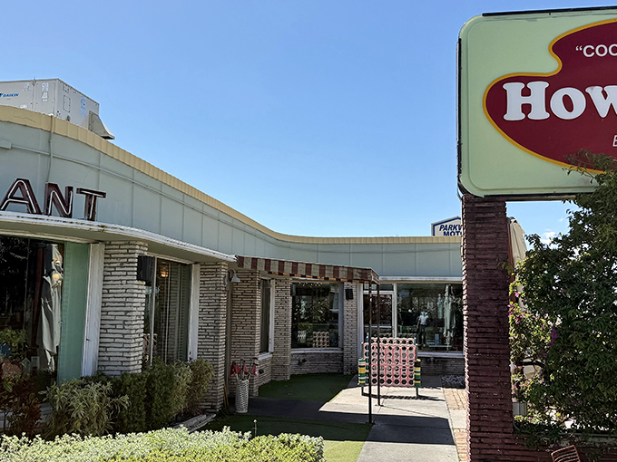 The mint-green exterior of Howley's stands as a mid-century modern beacon on South Dixie Highway, promising comfort food with a side of nostalgia.