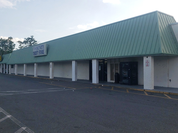 The unassuming green-roofed exterior of Community Thrift Store&mdash;proof that the best treasures often hide behind the most modest facades.