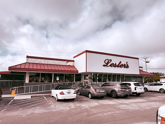 The classic red-and-white exterior of Lester's stands like a beacon of comfort food promise against the Florida sky.