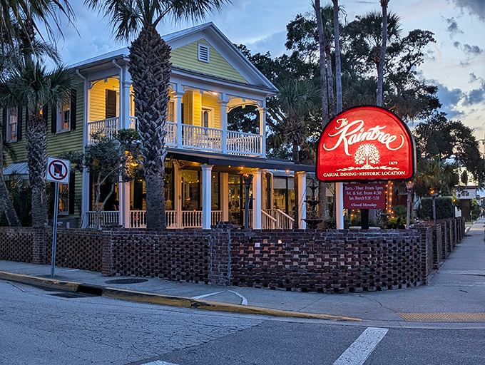 The yellow Victorian beauty stands proudly at twilight, its warm glow promising culinary adventures within. Palm trees and brick courtyard complete this St. Augustine treasure.