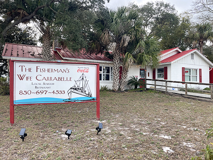 The classic white cottage with its cheerful red trim beckons seafood lovers like a lighthouse guiding hungry sailors home.