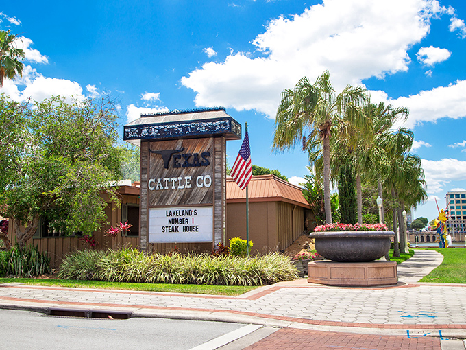The unassuming exterior of Texas Cattle Company stands like a carnivore's oasis amid Lakeland's palm trees, promising meaty delights behind its rustic wooden fa&ccedil;ade.