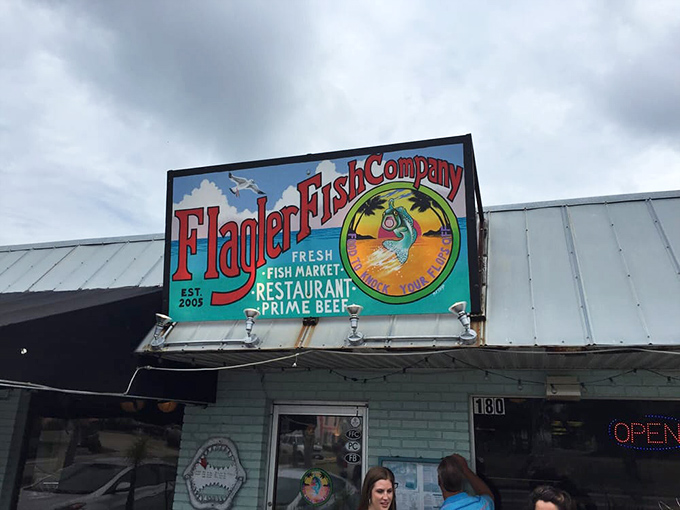 The vibrant sign says it all &ndash; fresh fish, cold drinks, and Florida sunshine await at this unassuming coastal gem.