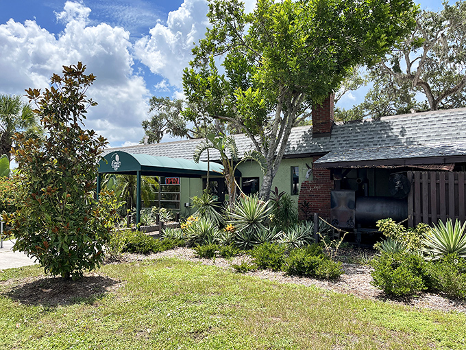 The unassuming entrance to Linger Lodge beckons with Old Florida charm. Palm trees and native plants frame this quirky culinary adventure waiting to happen.