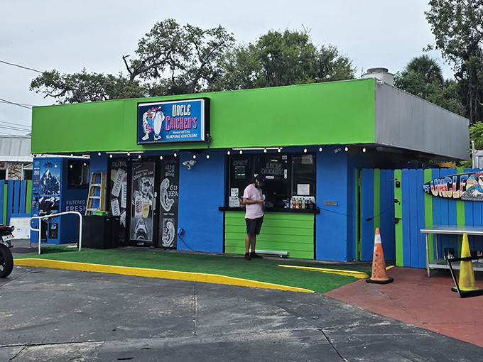 The surfing chicken beckons from this vibrant blue sign &ndash; a promise of coastal flavor that's about to change your fried chicken expectations forever.