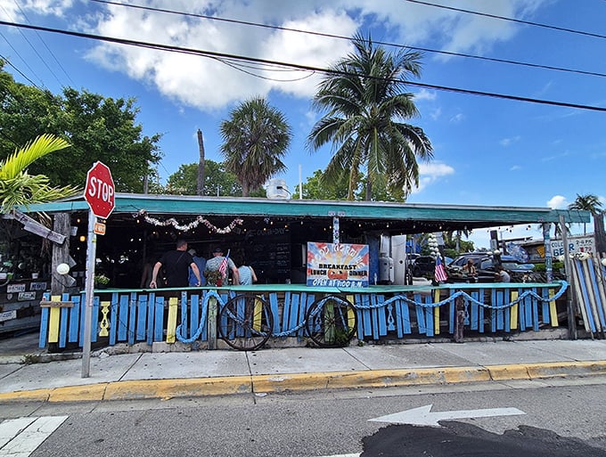 The blue and white striped entrance beckons like a siren song for seafood lovers seeking authentic Key West flavors.