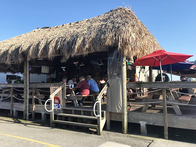 The classic thatched-roof entrance beckons like a tropical mirage after a long drive. Florida's version of "if you build it, they will come."