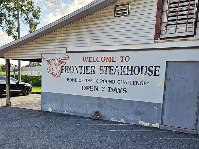 The unassuming exterior hides culinary treasures within. Like finding a diamond in a strip mall, Frontier's "6 Pound Challenge" sign promises carnivorous adventures ahead.