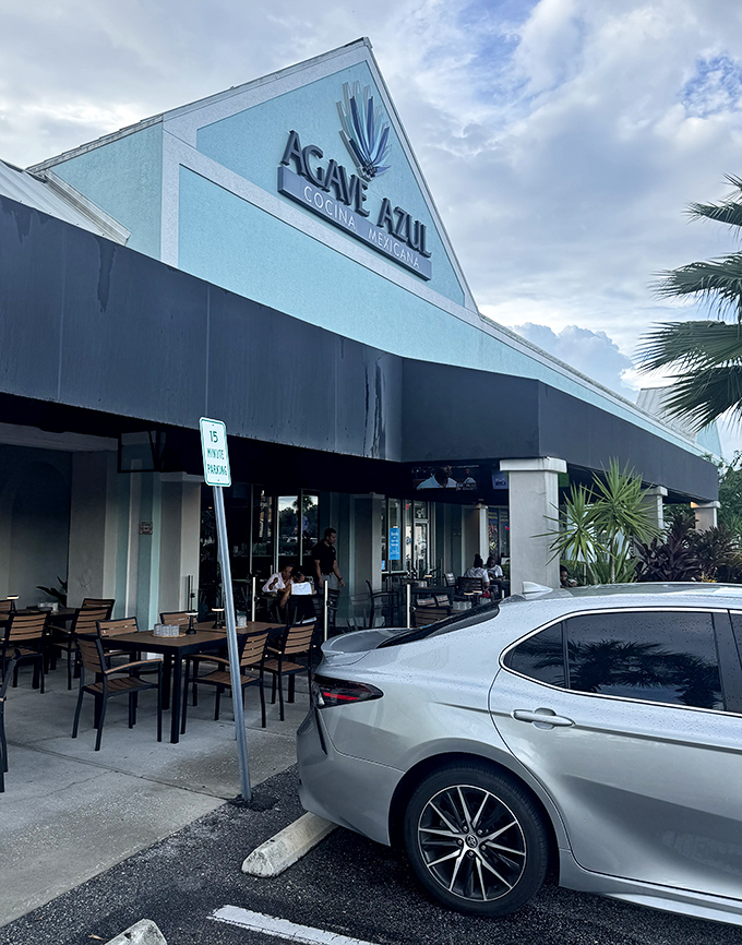 The distinctive turquoise exterior of Agave Azul stands out like a tropical oasis in Orlando's shopping center landscape, promising authentic Mexican flavors within.