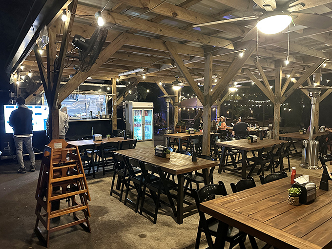 Rustic wooden beams and string lights create a magical dining atmosphere that feels like Florida's most delicious treehouse after dark.