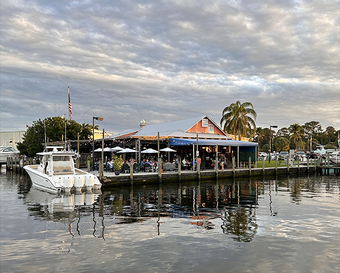 Paradise doesn't need a fancy entrance – just boats, water, and the promise of perfectly fried fish waiting inside.
