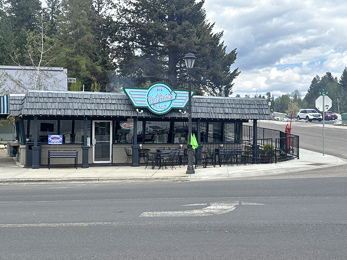 The iconic turquoise sign of My Father's Place stands out against McCall's mountain backdrop, promising burger perfection at this beloved corner establishment.