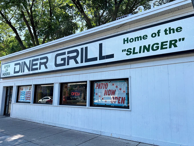 The unassuming white exterior of Diner Grill stands like a culinary lighthouse, beckoning hungry souls with its promise of 24-hour comfort.
