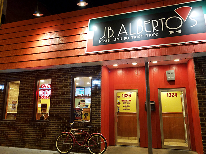 The bright red facade of J.B. Alberto's glows like a beacon in the night, promising pizza salvation to hungry Chicagoans.