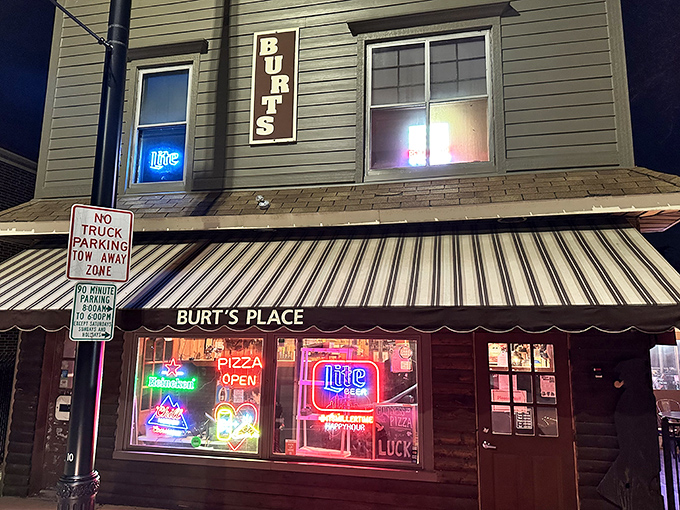 The unassuming exterior of Burt's Place glows with neon promise as night falls, a beacon for pizza pilgrims seeking deep-dish enlightenment.