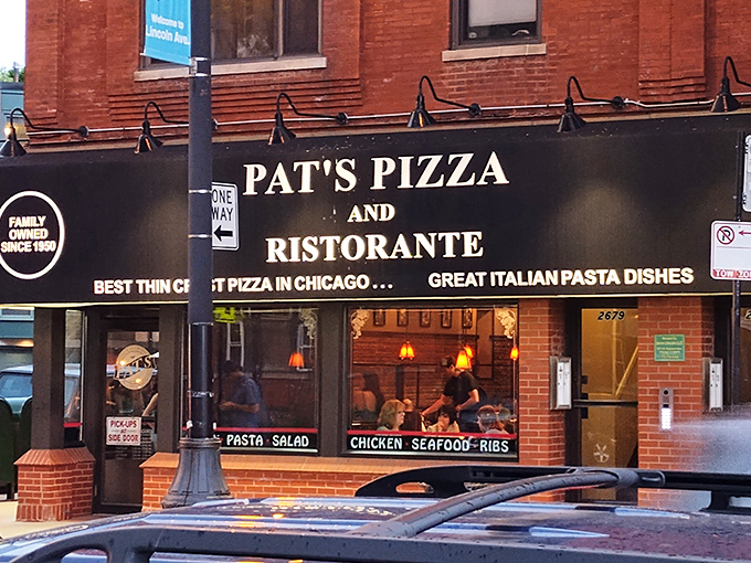Pat&rsquo;s Pizza & Ristorante&rsquo;s classic brick exterior and glowing sign make it a welcoming landmark for pizza lovers along Lincoln Avenue after dark.