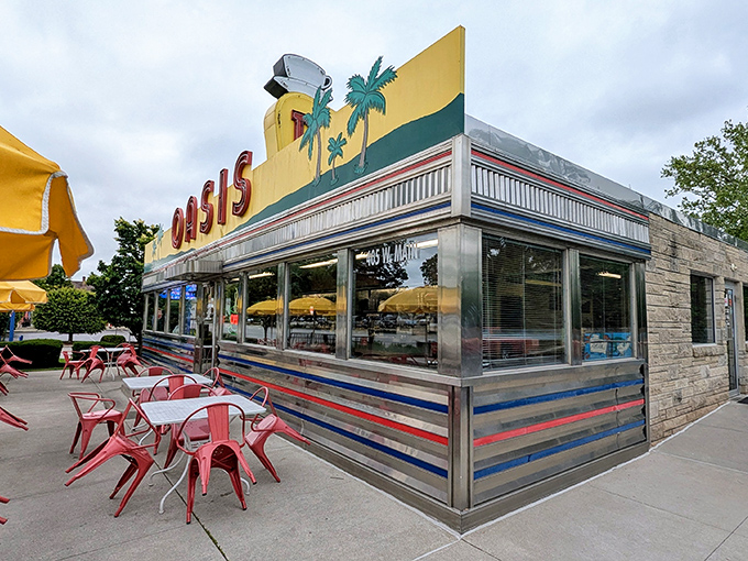 From another angle, the diner's streamlined aluminum exterior catches the light like a vintage Airstream trailer that decided to settle down and feed people instead.