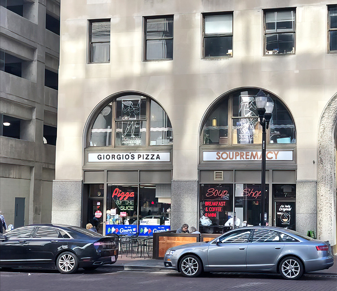 The iconic arched entrance to Giorgio's Pizza stands as a downtown Indianapolis landmark, beckoning hungry passersby with its neon promise of slice perfection.