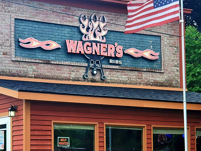 The iconic Wagner's Ribs sign stands as a beacon of barbecue hope, complete with flames and crossed utensils &ndash; the universal symbol for "prepare your taste buds for glory."
