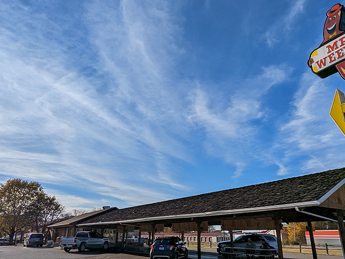 The iconic Mr. Weenie sign stands tall against Indiana's blue sky, a beacon of hope for hungry travelers and a promise of simple pleasures ahead.