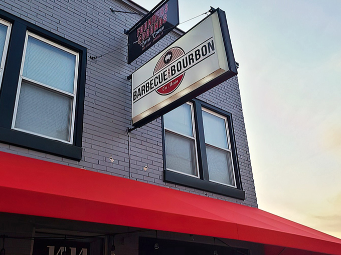 The bright red awning and classic signage of Barbecue and Bourbon stands out against Speedway's brick buildings like a beacon for hungry race fans and locals alike.