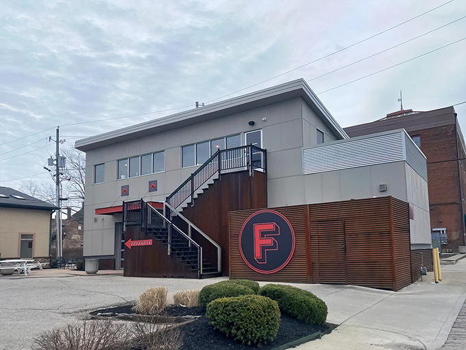 The unassuming exterior of Futuro, with its bold red "F" logo, proves that architectural modesty often hides culinary magnificence.