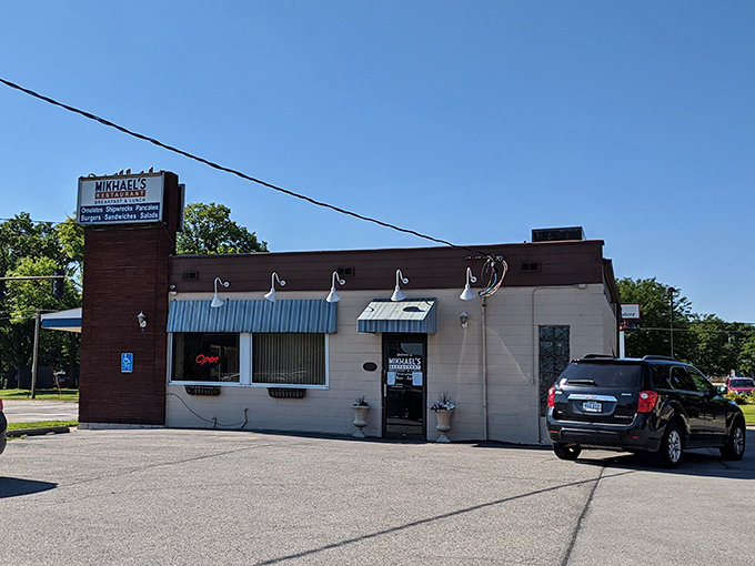 Unassuming brick exterior with blue awnings that whispers "nothing fancy here" while hiding Cedar Rapids' breakfast treasure behind modest walls.