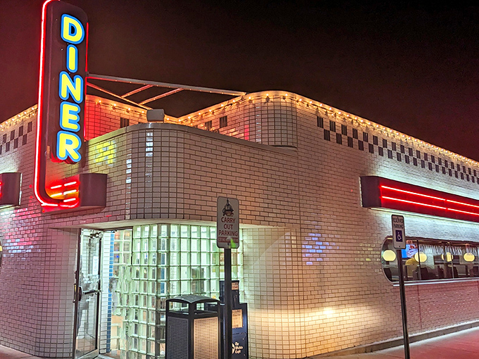 The neon glow of Jimmie's Diner cuts through the night like a beacon for hungry souls. Mid-century architecture meets modern appetite in this Wichita landmark.