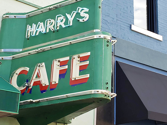The iconic green sign of Harry's Caf&eacute; stands as a beacon of burger perfection in downtown Pittsburg, promising culinary treasures that locals have treasured for generations.