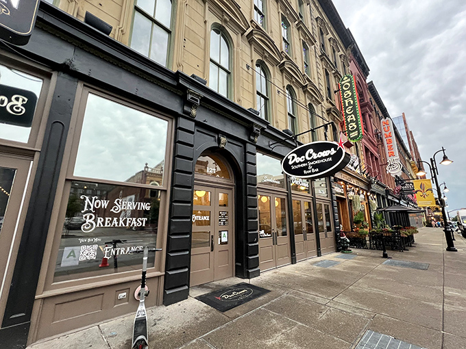 Historic charm meets Southern hospitality on Louisville's Whiskey Row. The black facade and elegant signage promise smoky delights within.