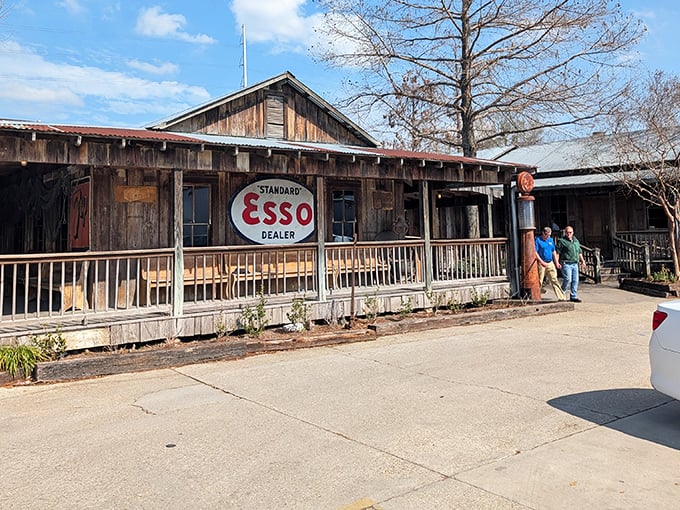 The rustic charm of Parrain's exterior, complete with vintage Esso sign, promises authentic Louisiana flavors hiding behind those weathered wooden walls.