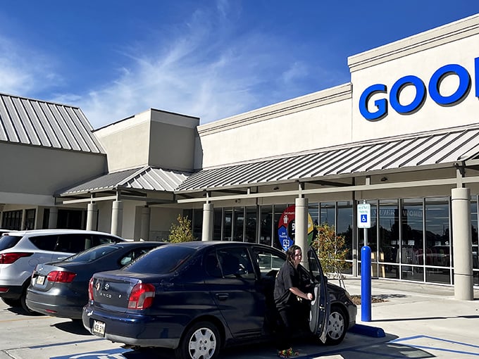 The bright blue Goodwill sign beckons like a lighthouse to treasure hunters navigating the sea of secondhand possibilities in Kenner.