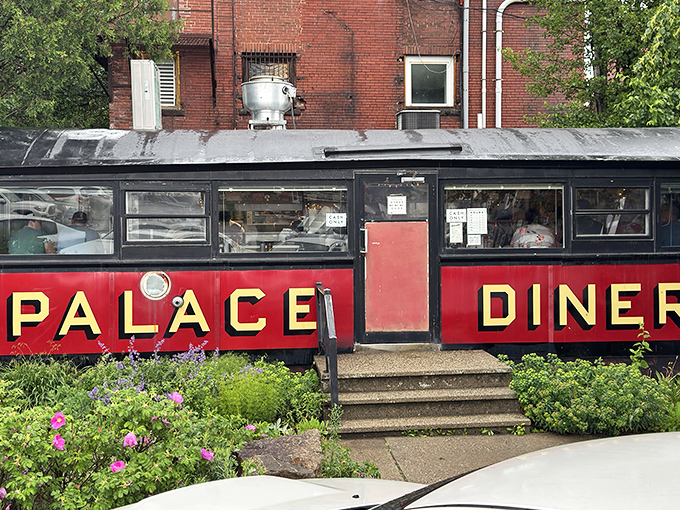 The Palace Diner's iconic red exterior with bold yellow lettering isn't just a restaurant&mdash;it's a time capsule on wheels that never left the station.